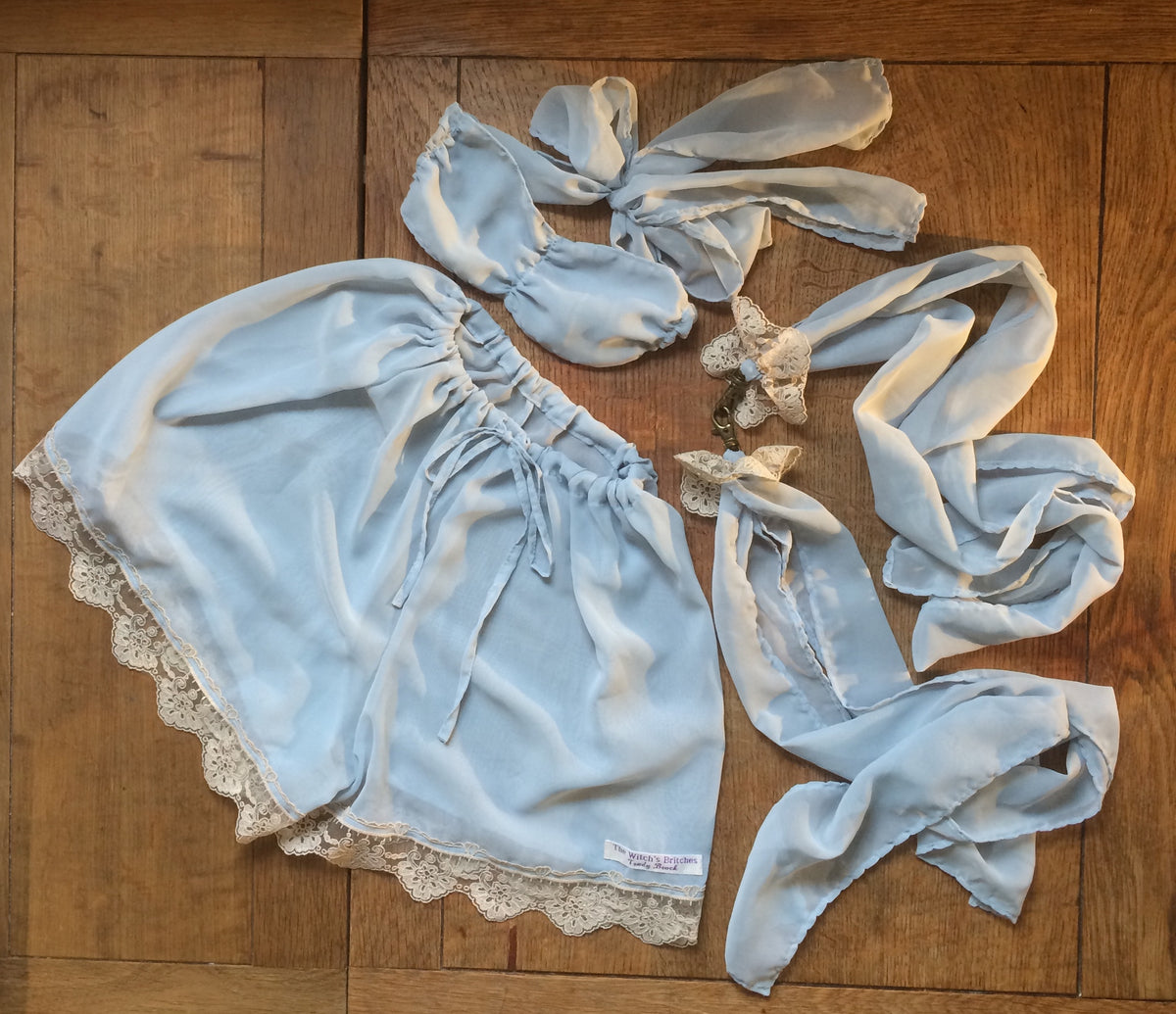 Dusky blue and white lace hand restraints – The Witch's Britches